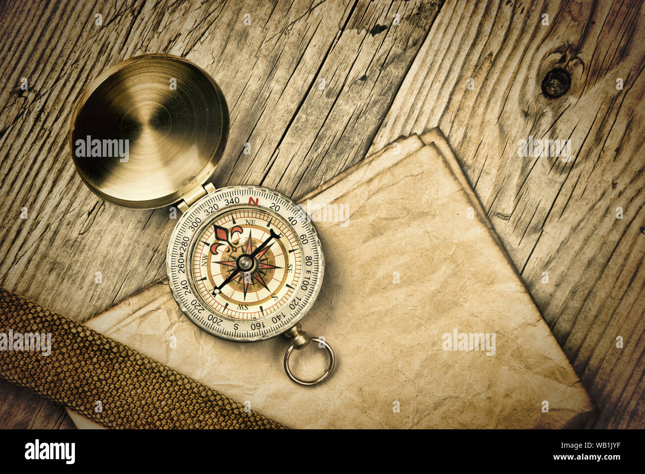 Vintage paper with compass on old wooden boards Stock Photo - Alamy