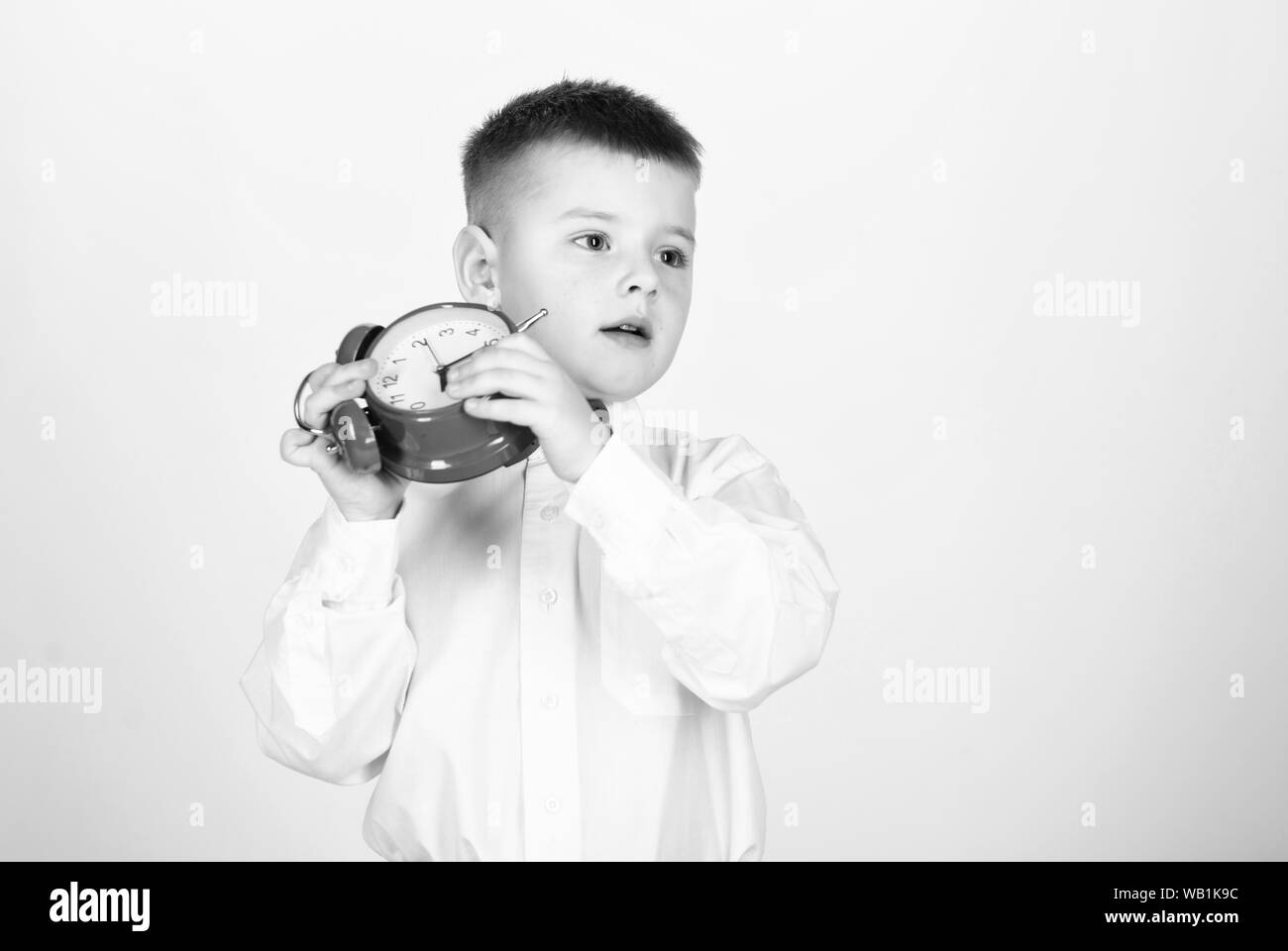 Morning routine. Schoolboy with alarm clock. Kid adorable boy white ...