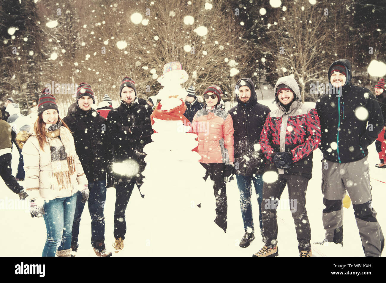 Group young people building snowman hi-res stock photography and images ...