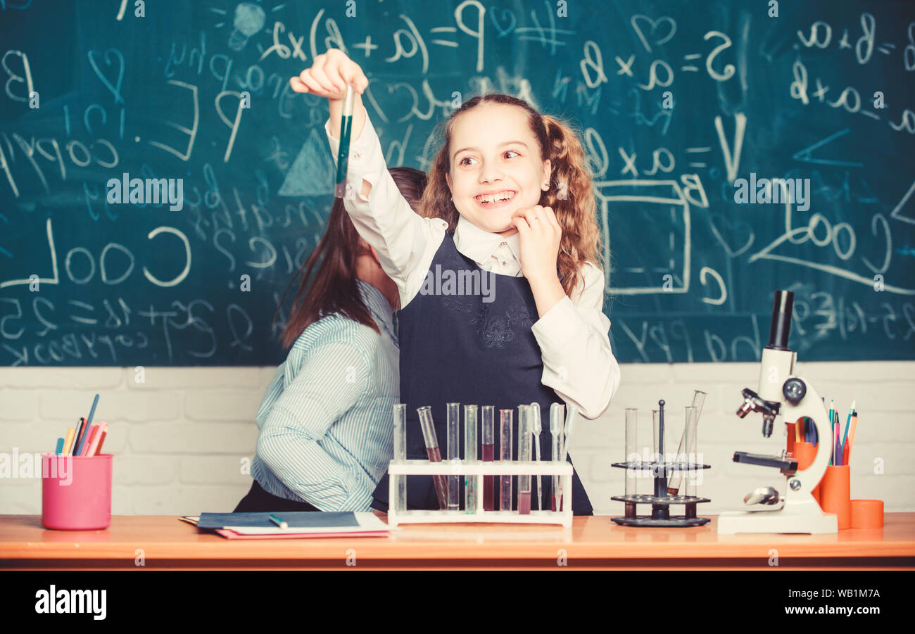 students doing biology experiments with microscope in lab. Happy ...