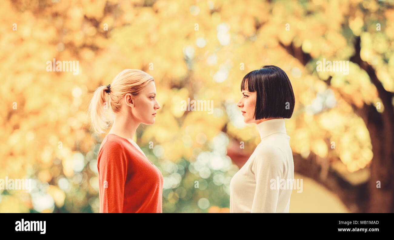 Pretty girls friends sisters. Eye contact. Women looking at each other ...