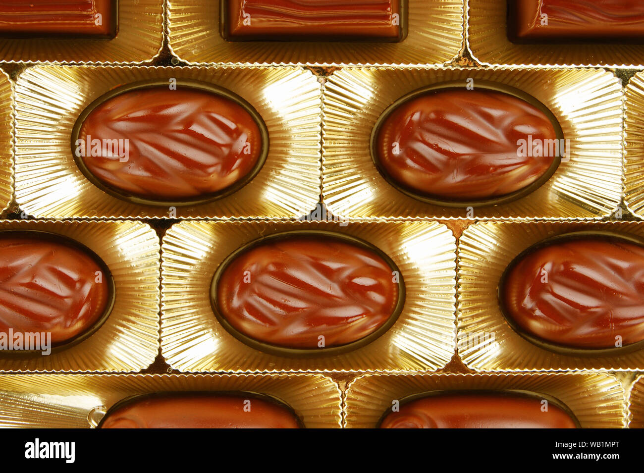 chocolate candies in a gold gift box Stock Photo - Alamy