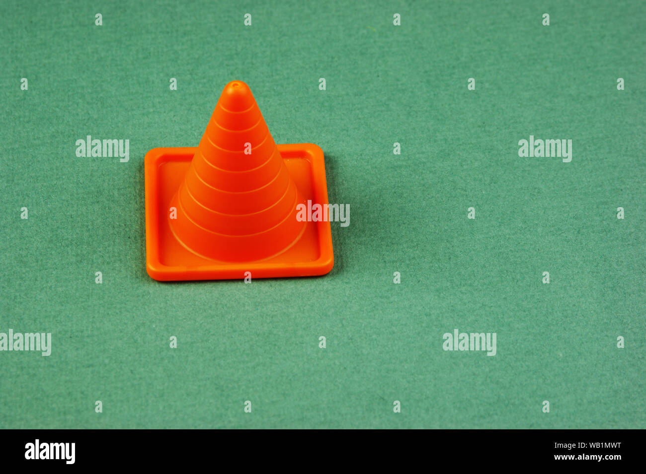 Plastic traffic cone on the green background Stock Photo - Alamy