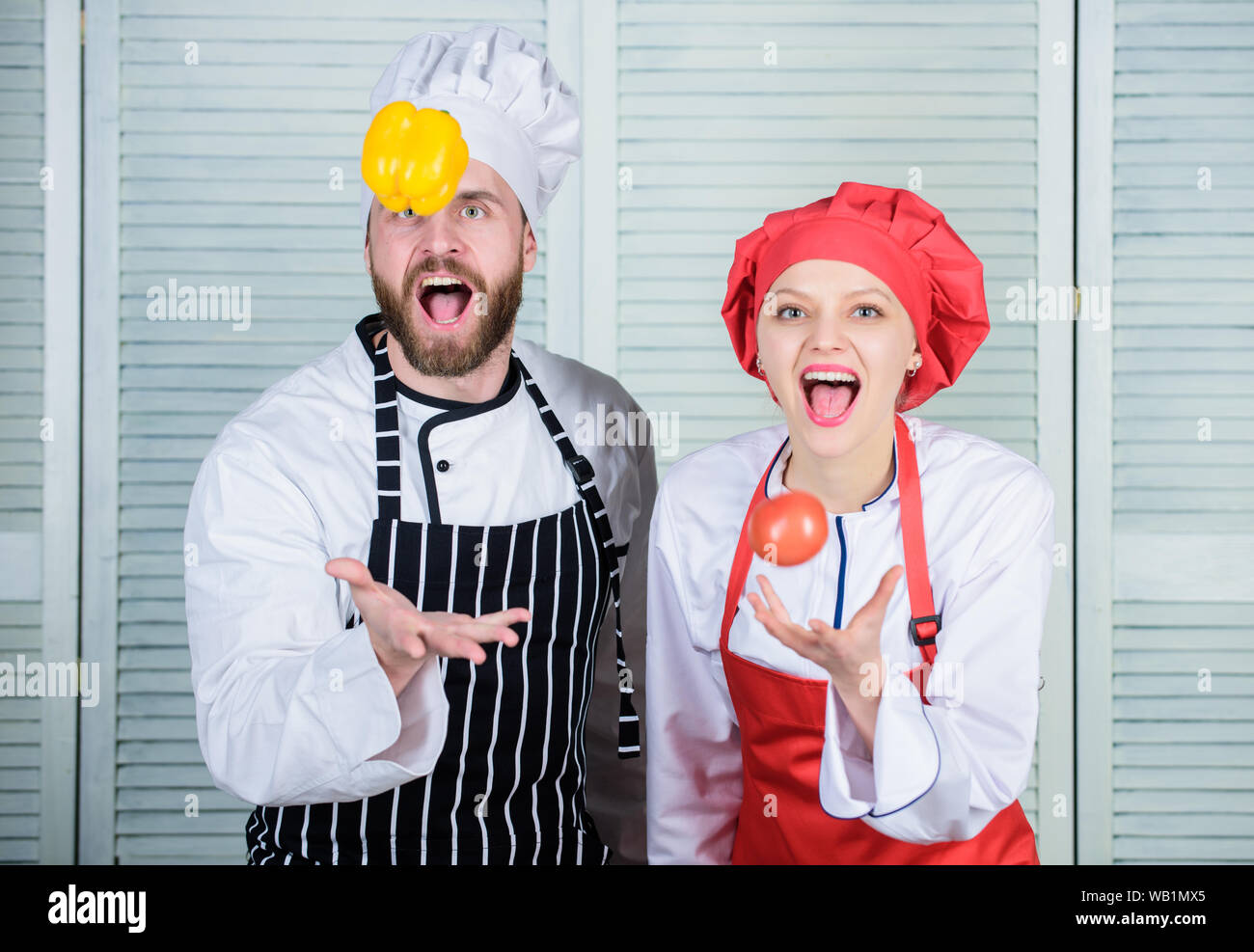 Just for fun. man and woman chef in restaurant. Family cooking in ...