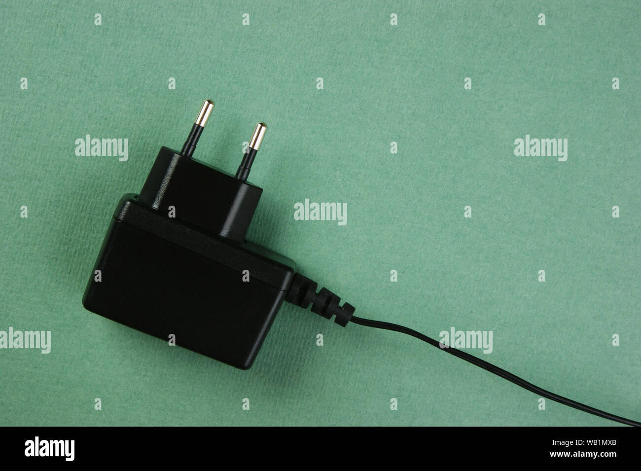 black charger adapter with plug on the green background Stock Photo - Alamy