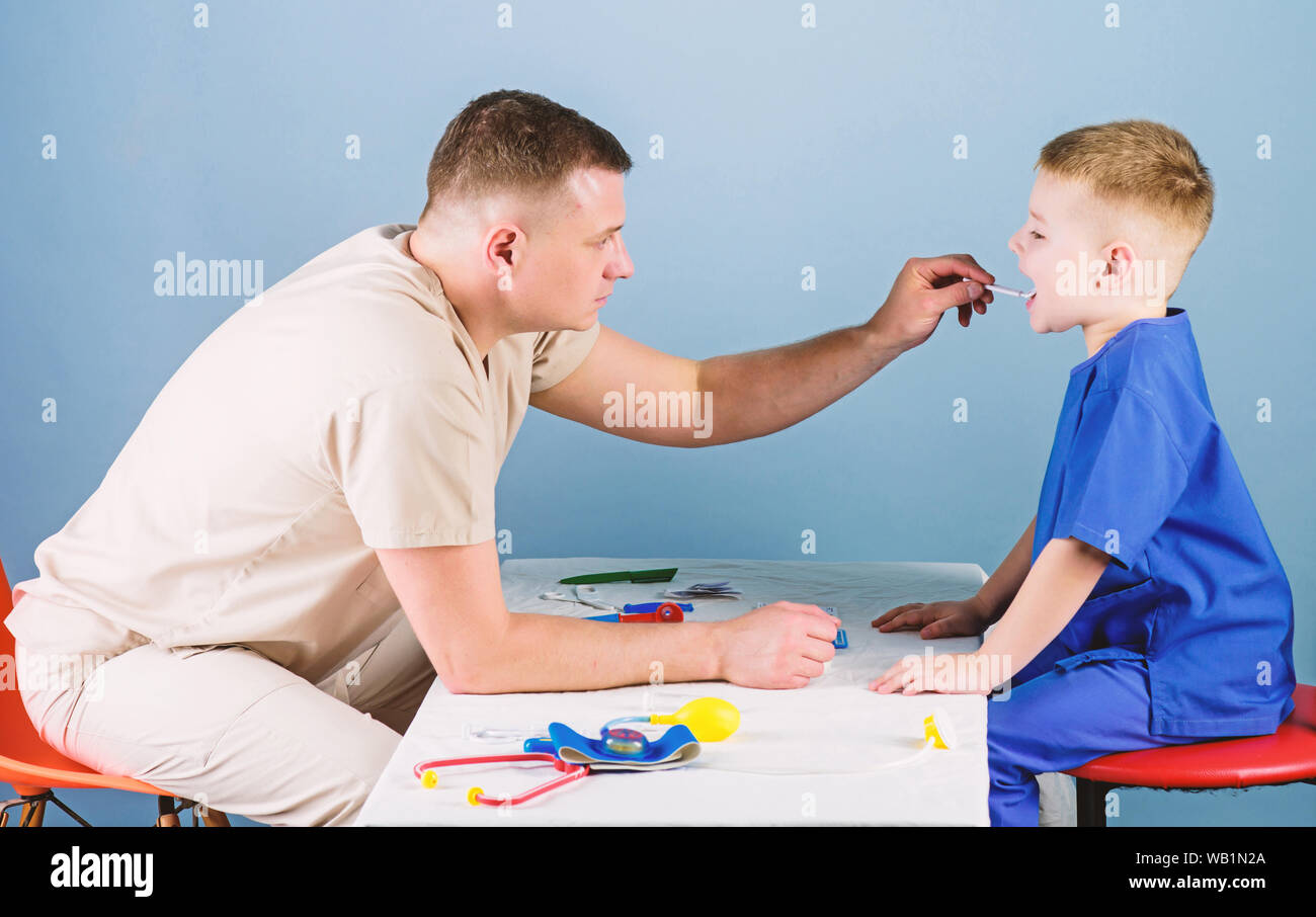Medical service. Man doctor sit table medical tools examining little ...