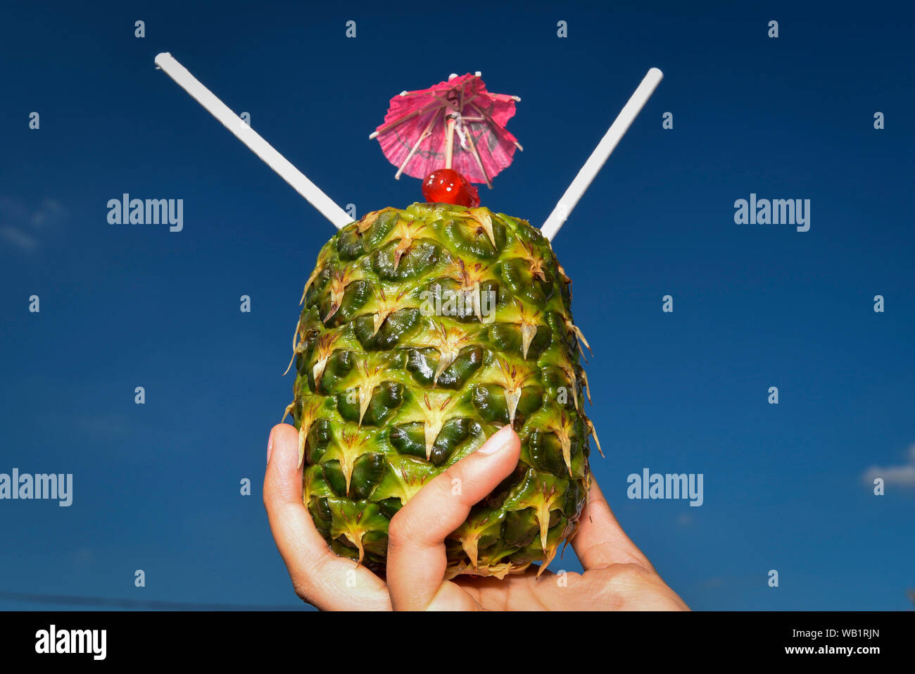 Watford, UK. 23 August 2019. A devotee holds up a a refreshing ...
