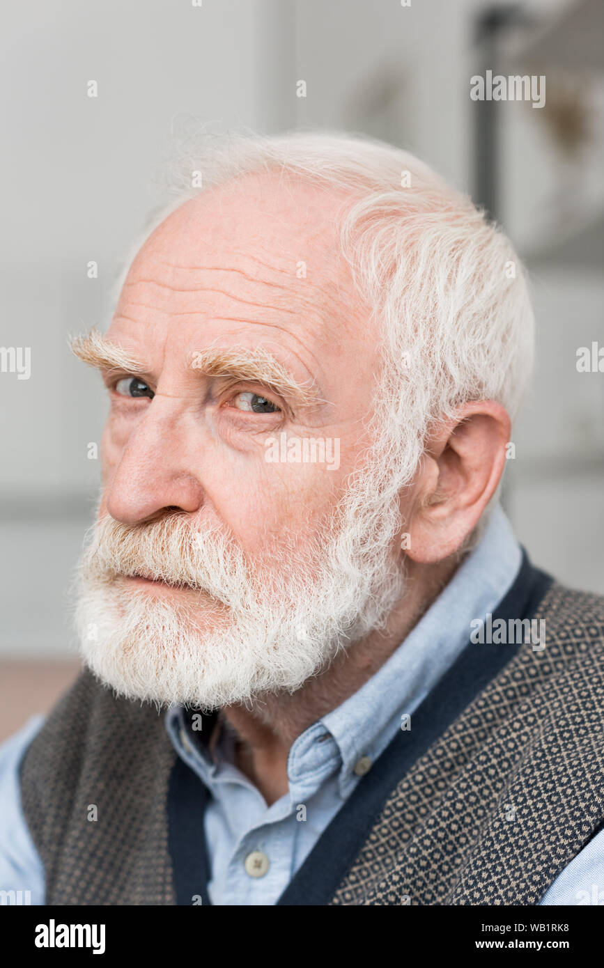 Sad and bearded grey haired man looking at camera Stock Photo - Alamy