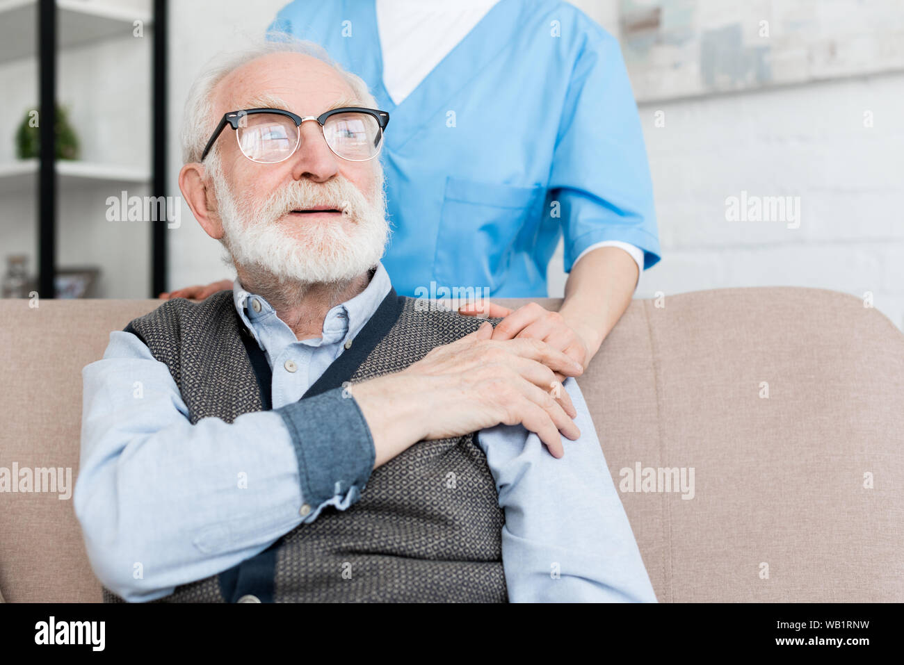 Doctor supporting elderly patient, putting hands on his shoulder Stock ...