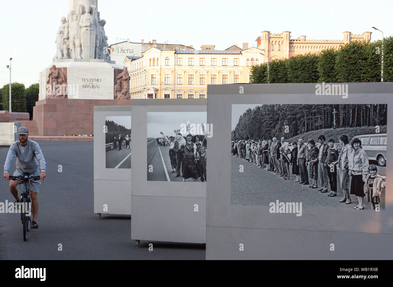 Riga, Latvia. 22nd Aug, 2019. A cyclist drives past the Freedom ...