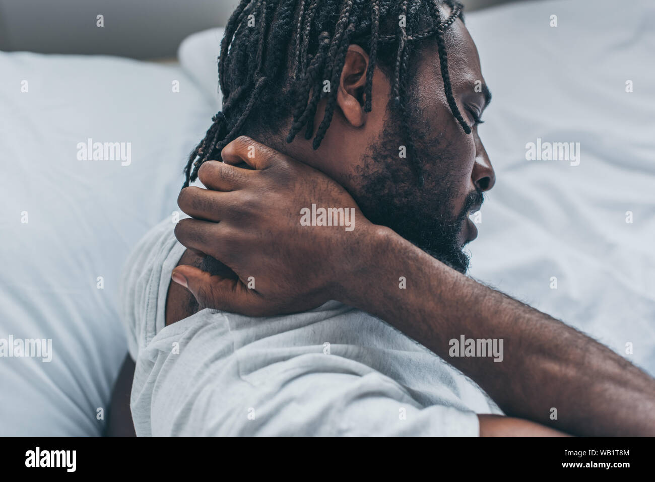 Tired young african man neck hi-res stock photography and images - Alamy