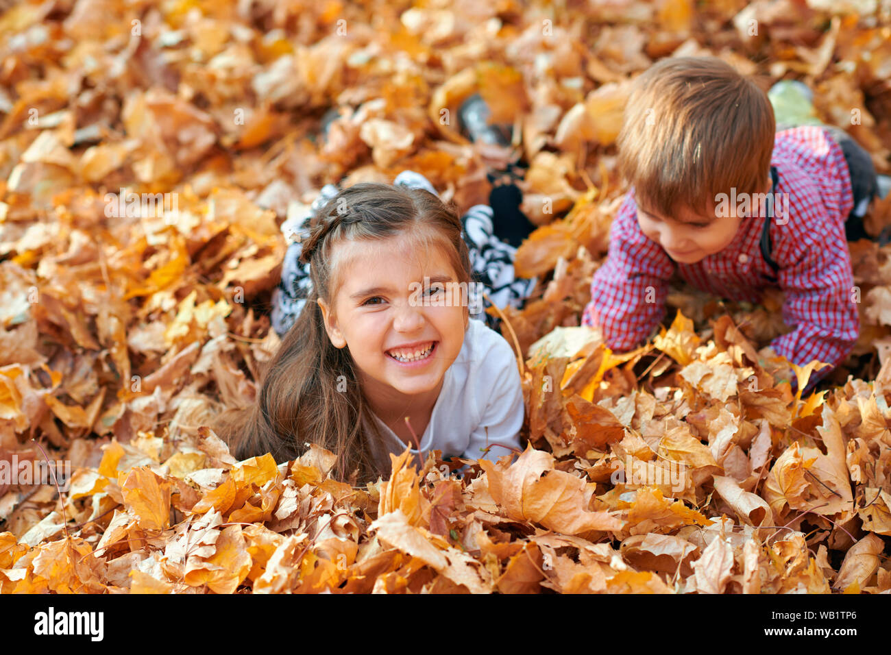 Happy children playing, posing, smiling and having fun in autumn city ...