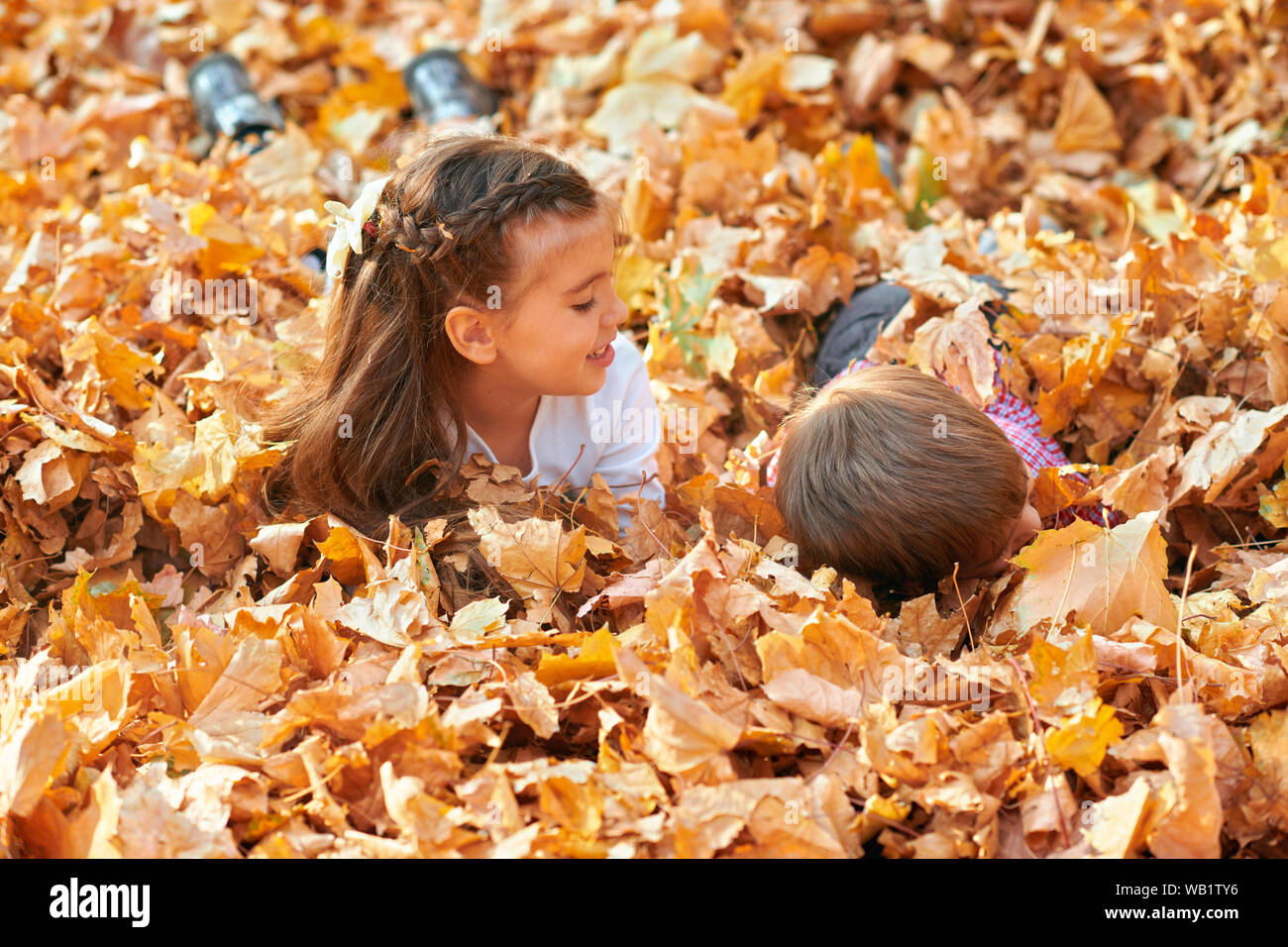 Happy children playing, posing, smiling and having fun in autumn city ...