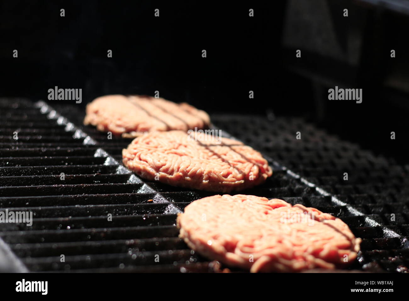 Raw burgers on bbq barbecue grill with fire. Food meat - raw burgers on ...