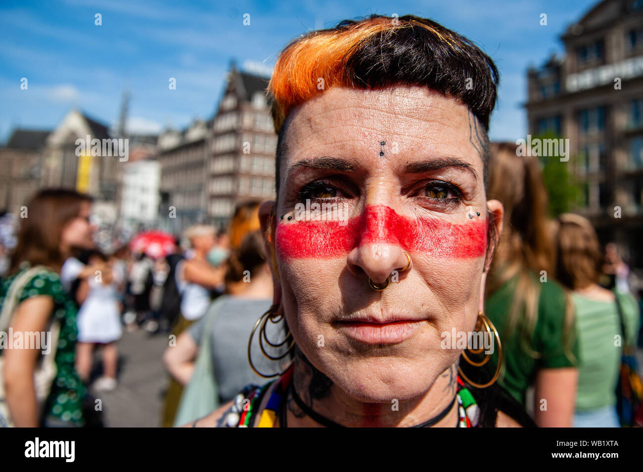 A woman wearing indigenous paint in her face takes part during the ...