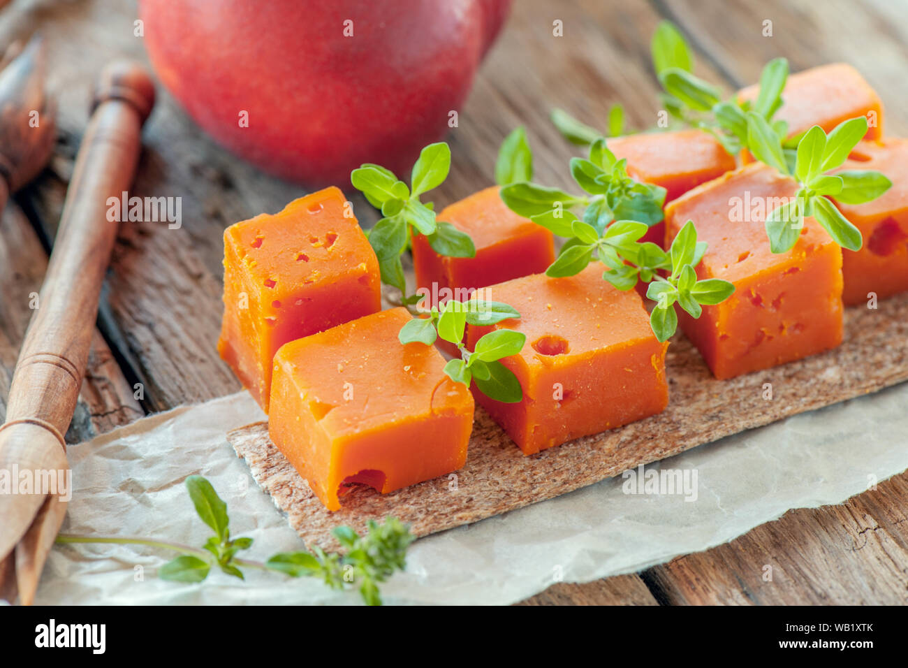 The pieces of red cheddar, on a beautiful textured wooden background ...