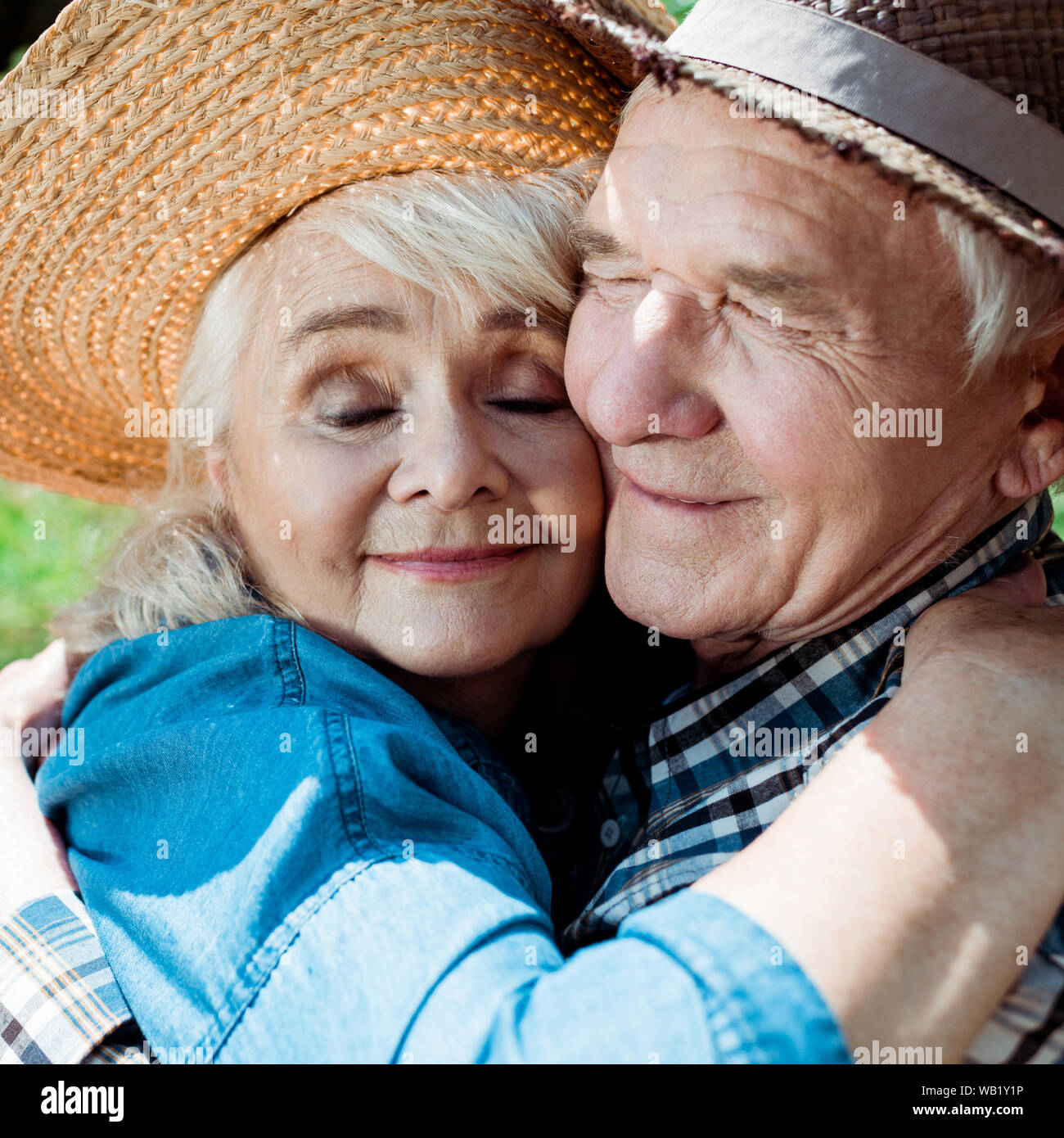 close up of cheerful senior woman hugging happy retired husband in ...