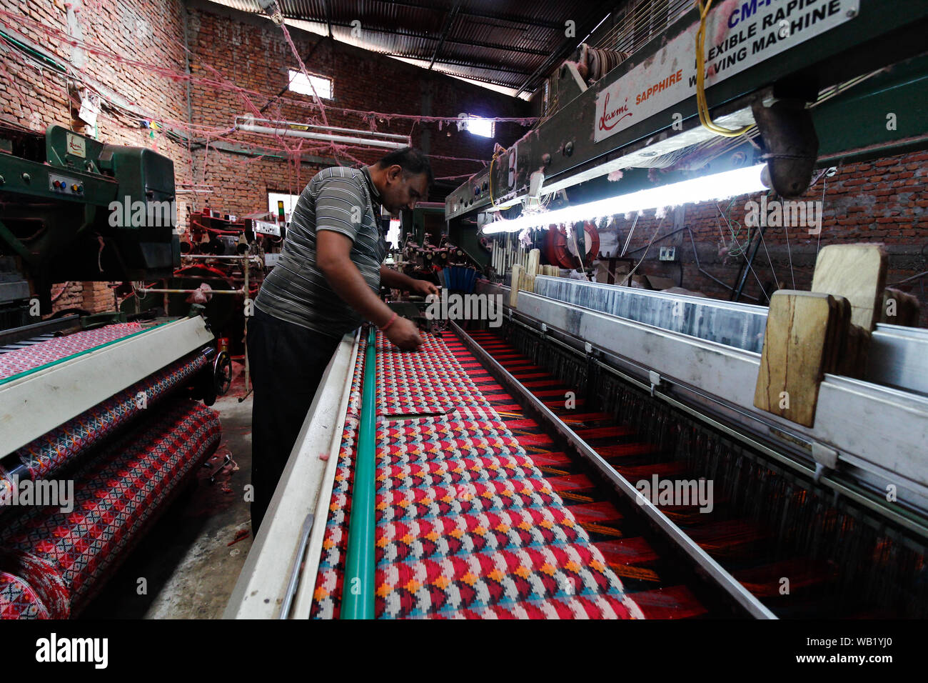 Man working in a textile factory in Lubhu, Lalitpur, Nepal on August 22 ...