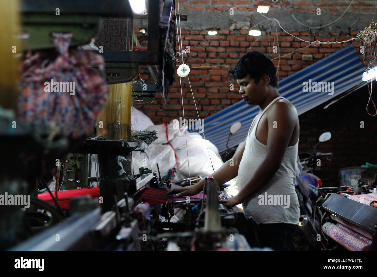 Man working in a textile factory in Lubhu, Lalitpur, Nepal on August 22 ...