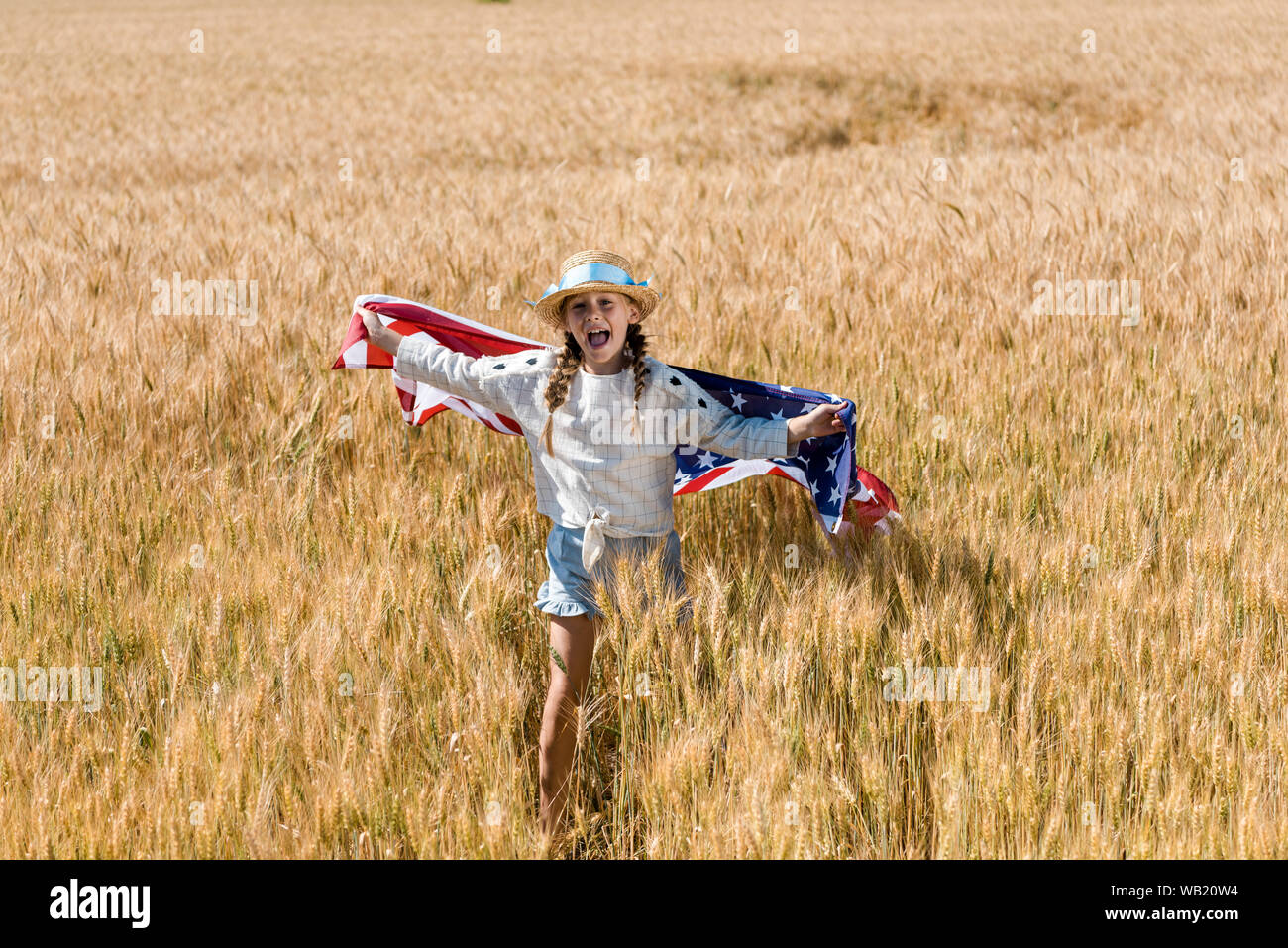 cute and happy kid holding american flag in golden field Stock Photo ...