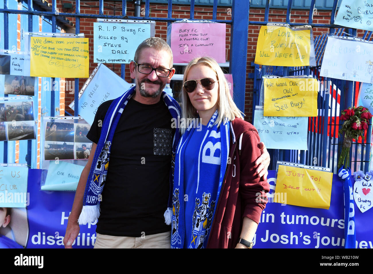 Bury fans pose for a photo in front of the gates at Gigg Lane, Bury ...