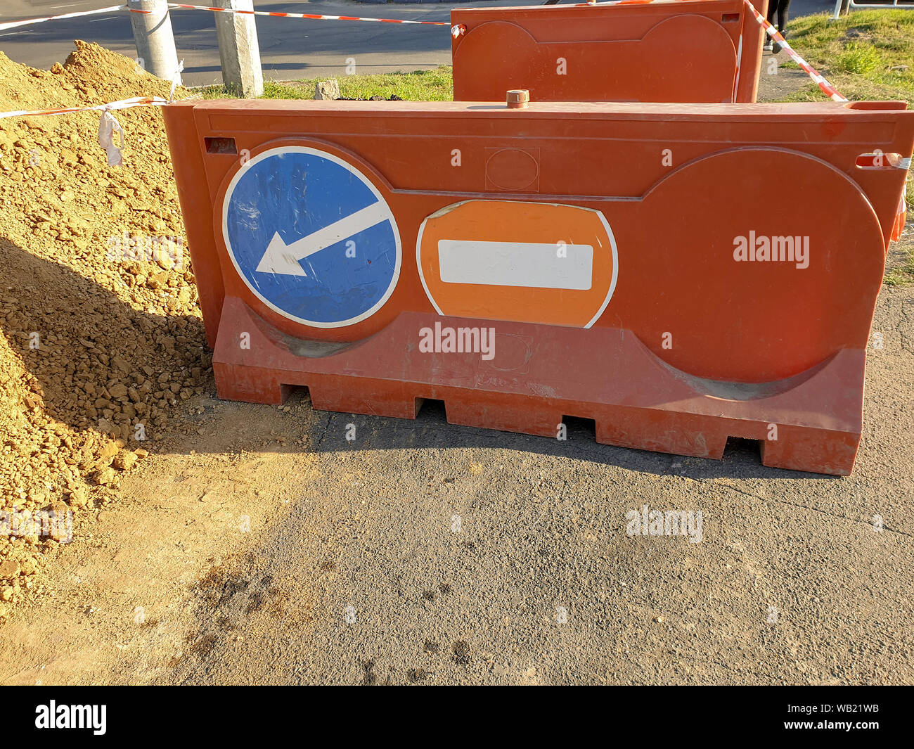 Road work on the sidewalk. Warning road signs on the fence around the ...