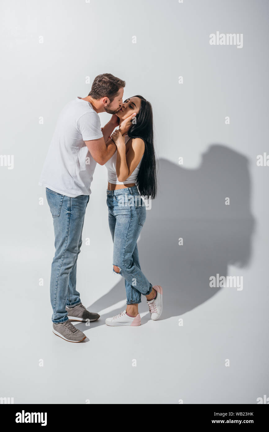 full length view of young man and girl kissing with closed eyes Stock ...
