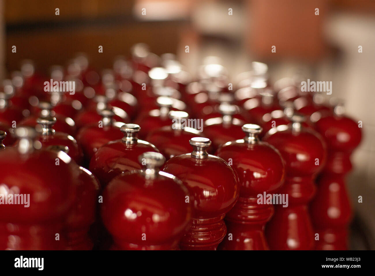 Red pepper shakers in line in restaurante prepping table Stock Photo ...