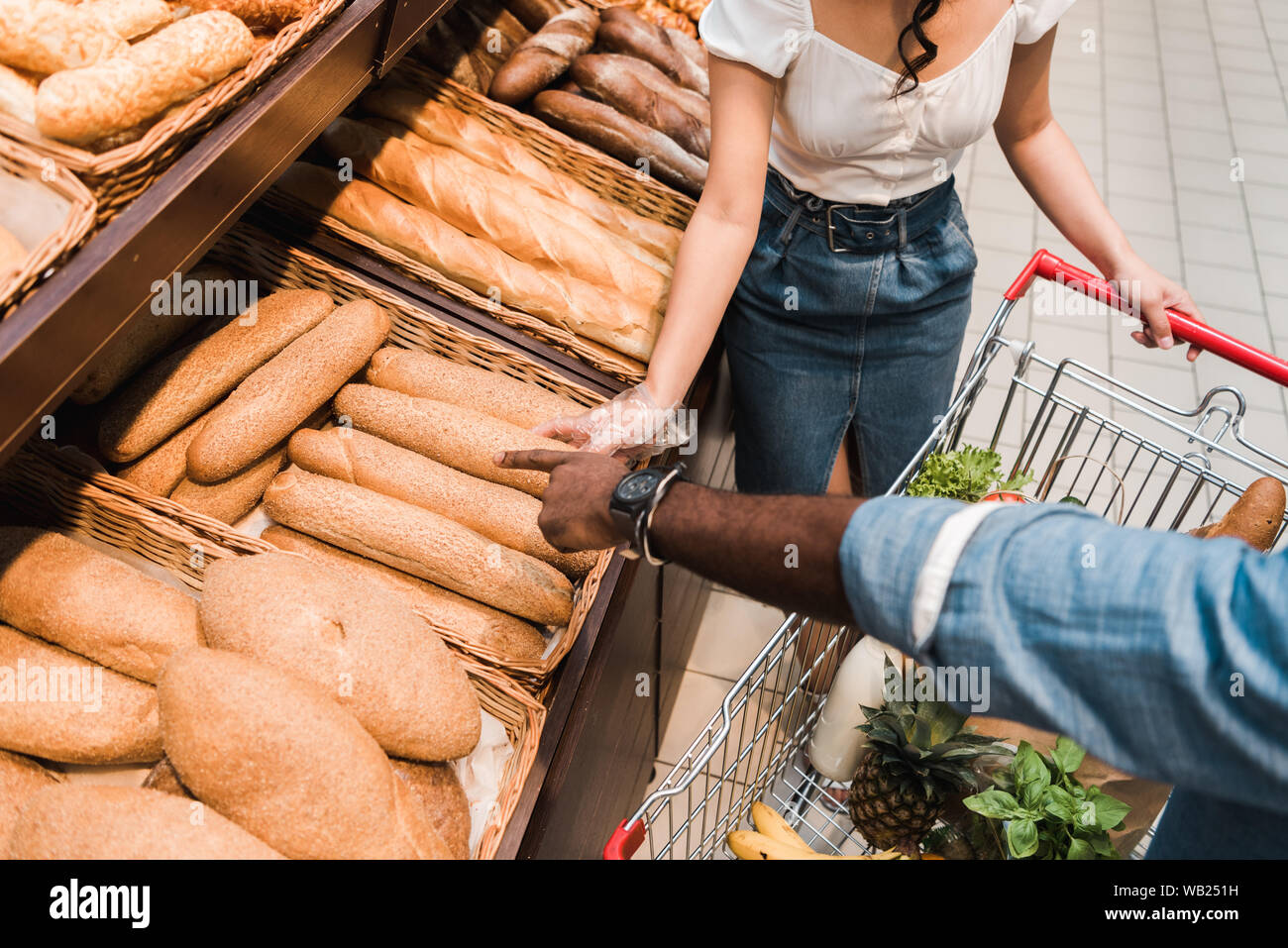 overhead view of african american man pointing with finger at bread in ...