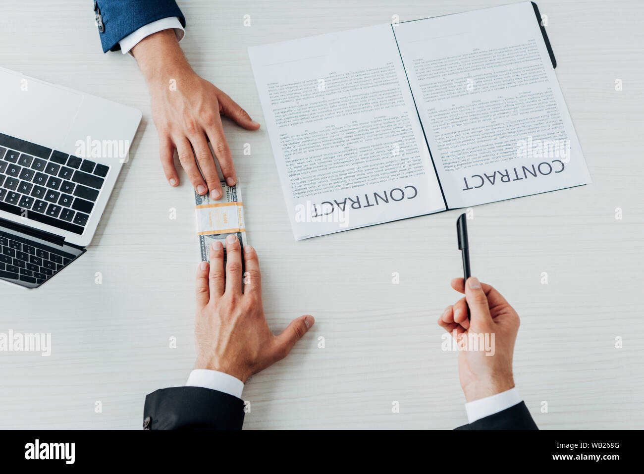 top view of man giving money and shaking hands with business partner ...