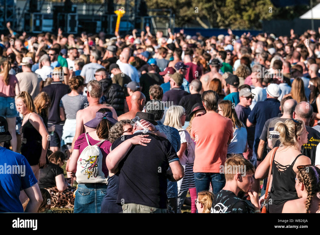 Portsmouth, Hampshire, UK. August 23rd 2019. Couple in festival crowd ...