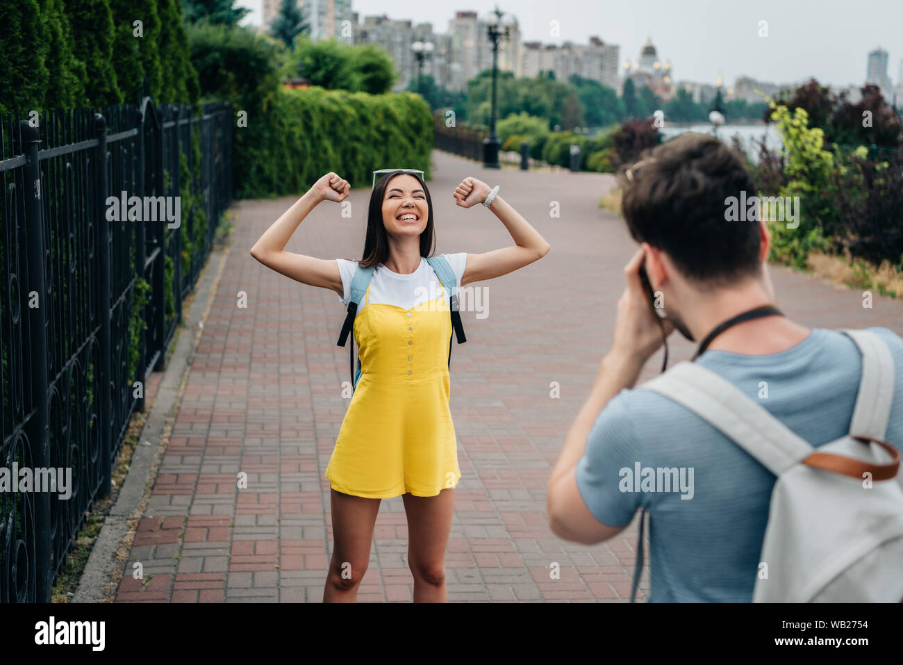 man taking photo and asian woman showing yes gesture Stock Photo - Alamy