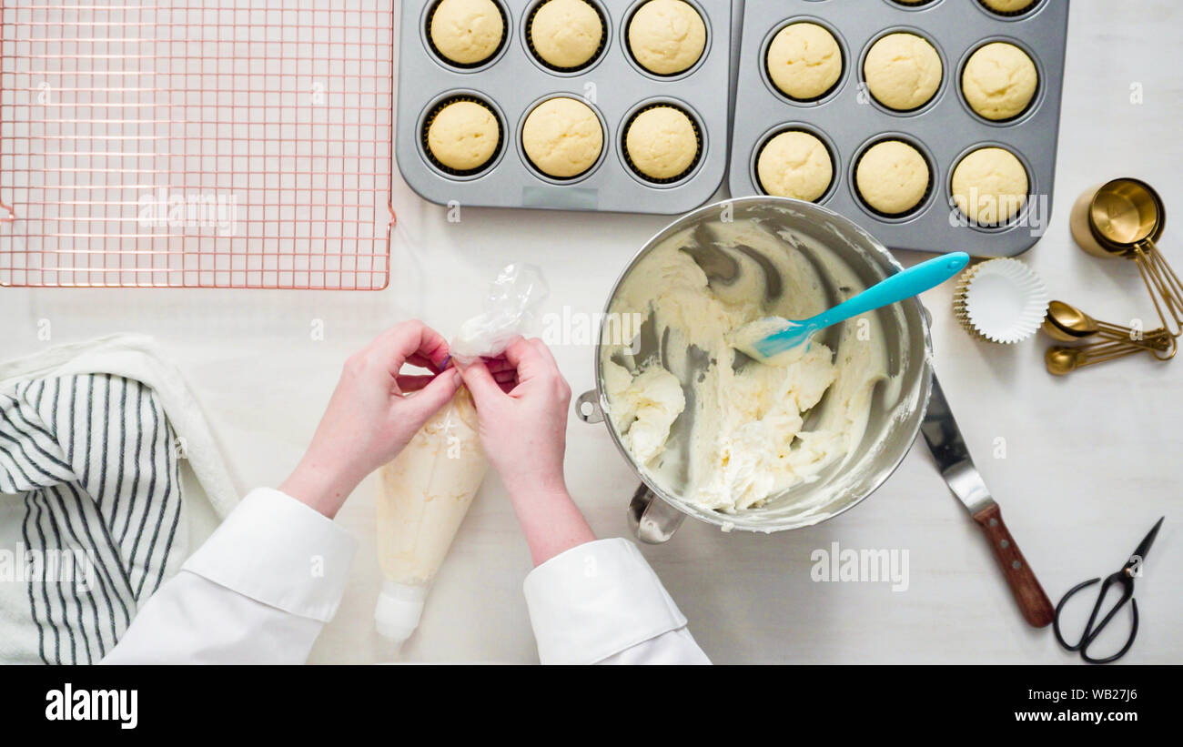 Flat lay. Step by step. Scooping a white buttercream frosting into a ...