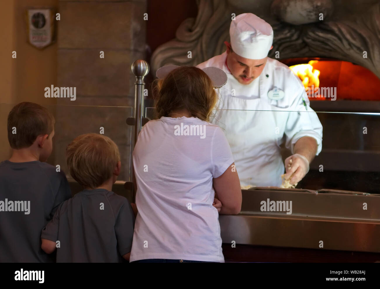 Orlando, FL USA. Feb 2016. Curious kids watching through glass ...