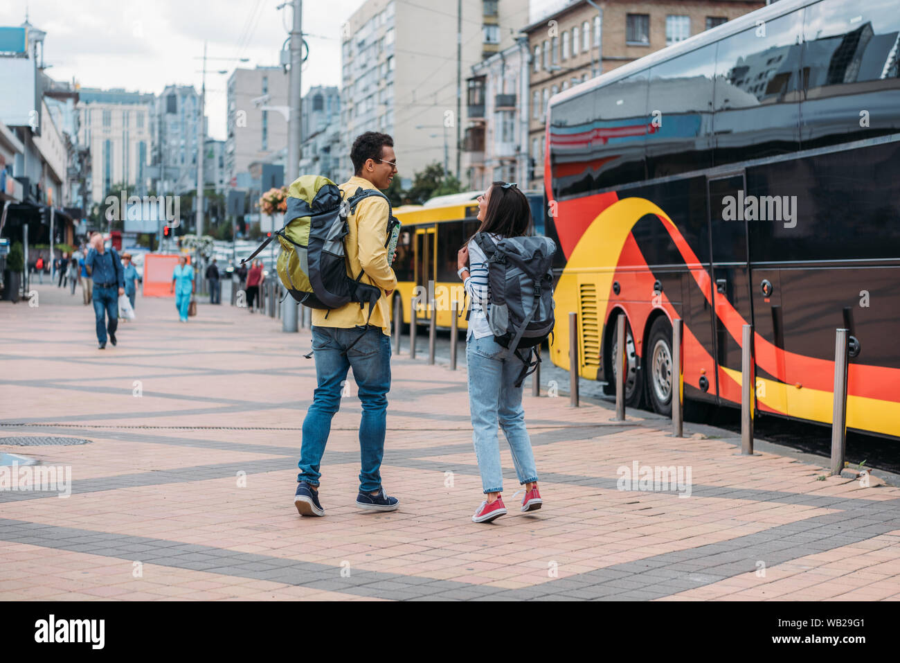 Back view of travelers with backpacks near travel bus Stock Photo - Alamy
