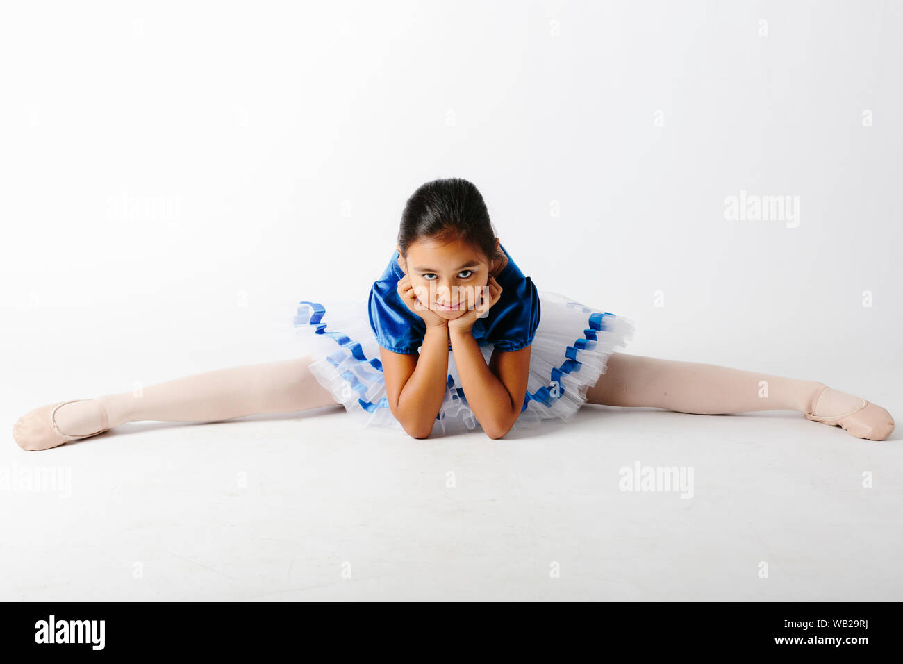 A 9-year old girl dressed on her ballerina outfit. She has hispanic ...