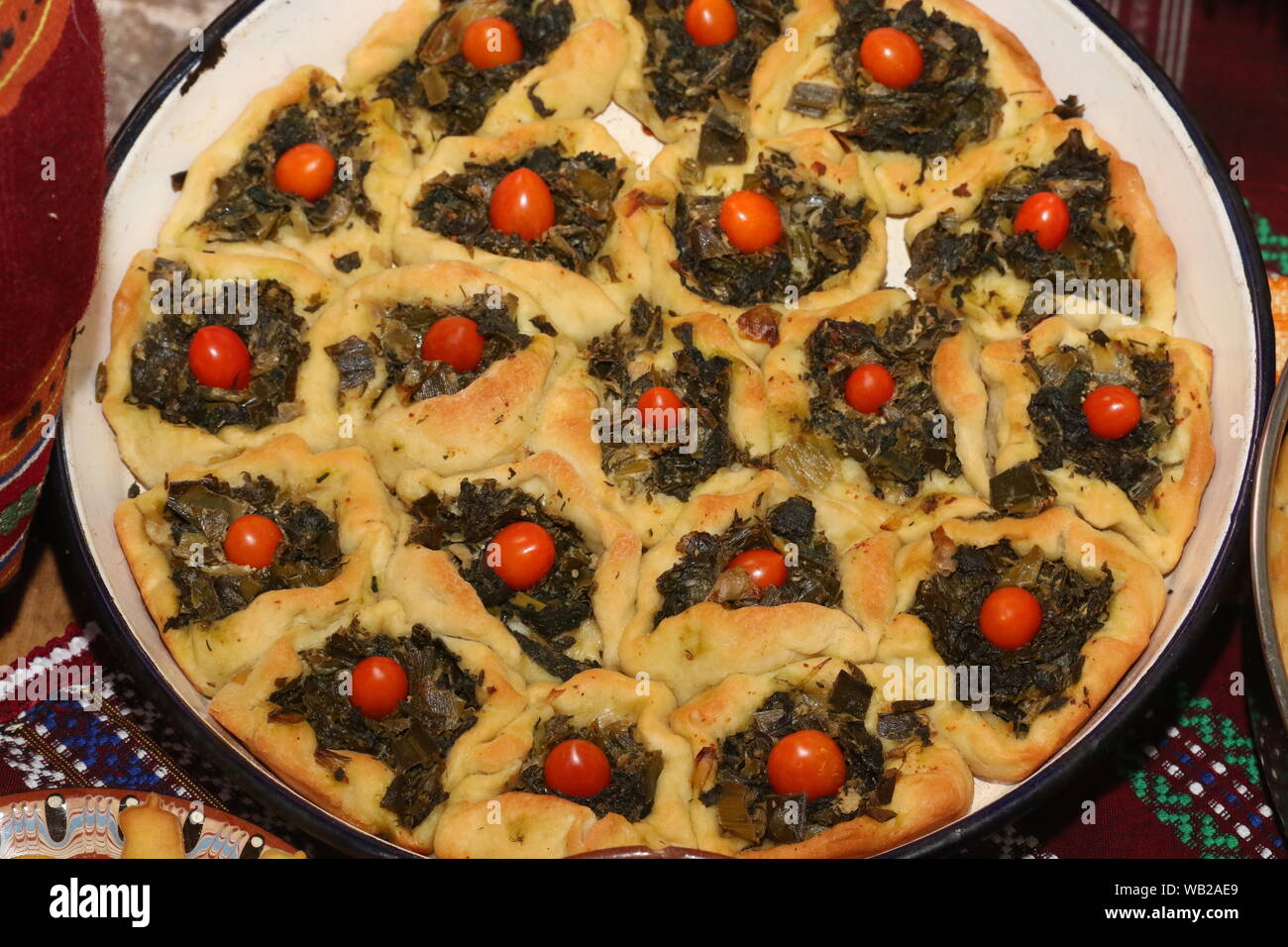 Freshly baked homemade bread arranged in traditional Bulgarian textiles ...