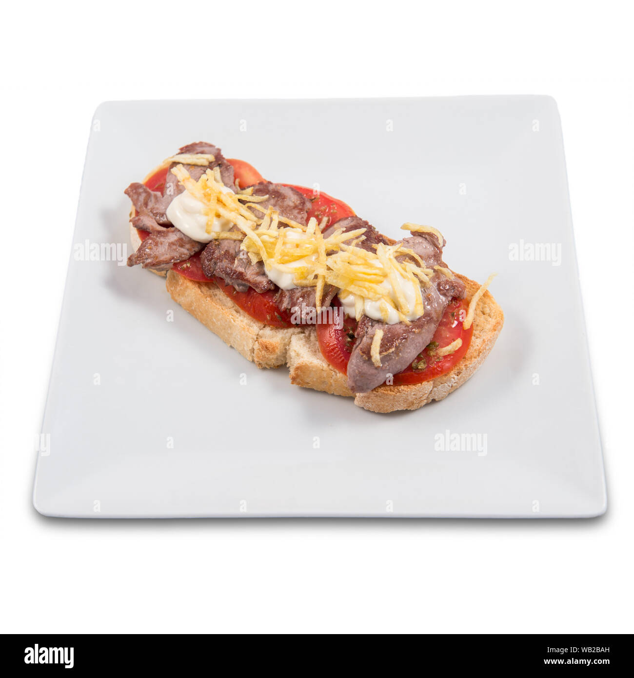Toast of Iberian pork sirloin on a natural tomato base Stock Photo - Alamy