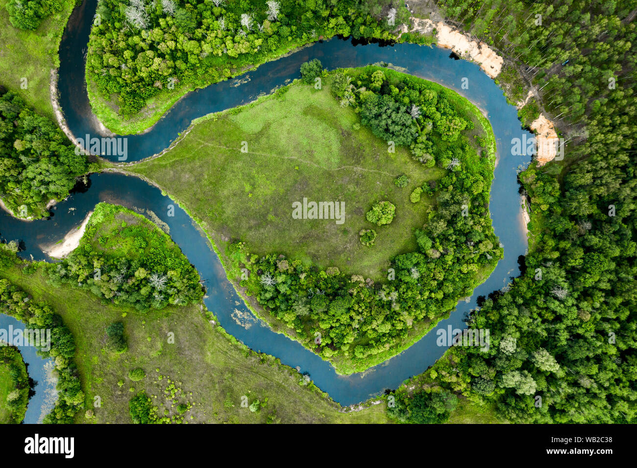 Top view of the beautiful landscape. Green field. Meandering river ...