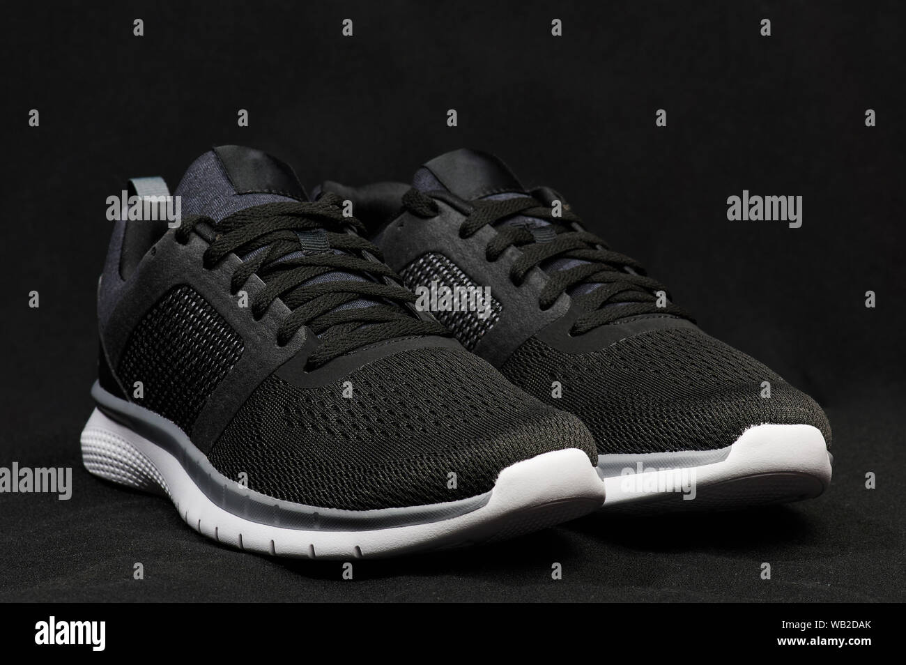 Angle view of modern dark shoes on blurred gray studio background Stock ...