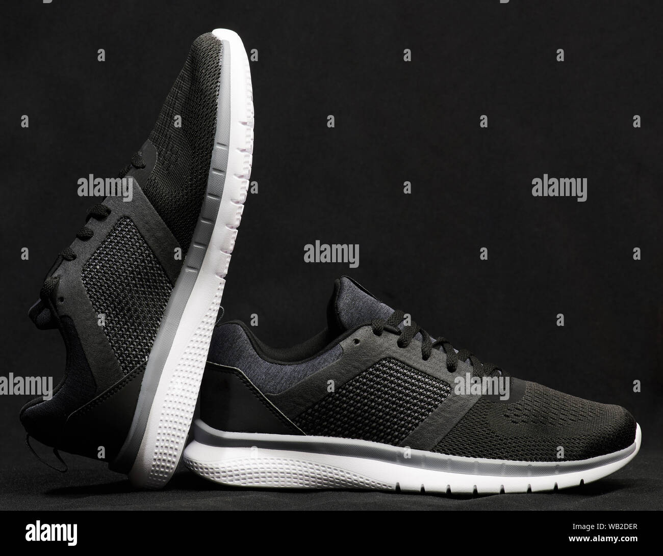 Sport trainer shoes stand on gray studio background Stock Photo - Alamy