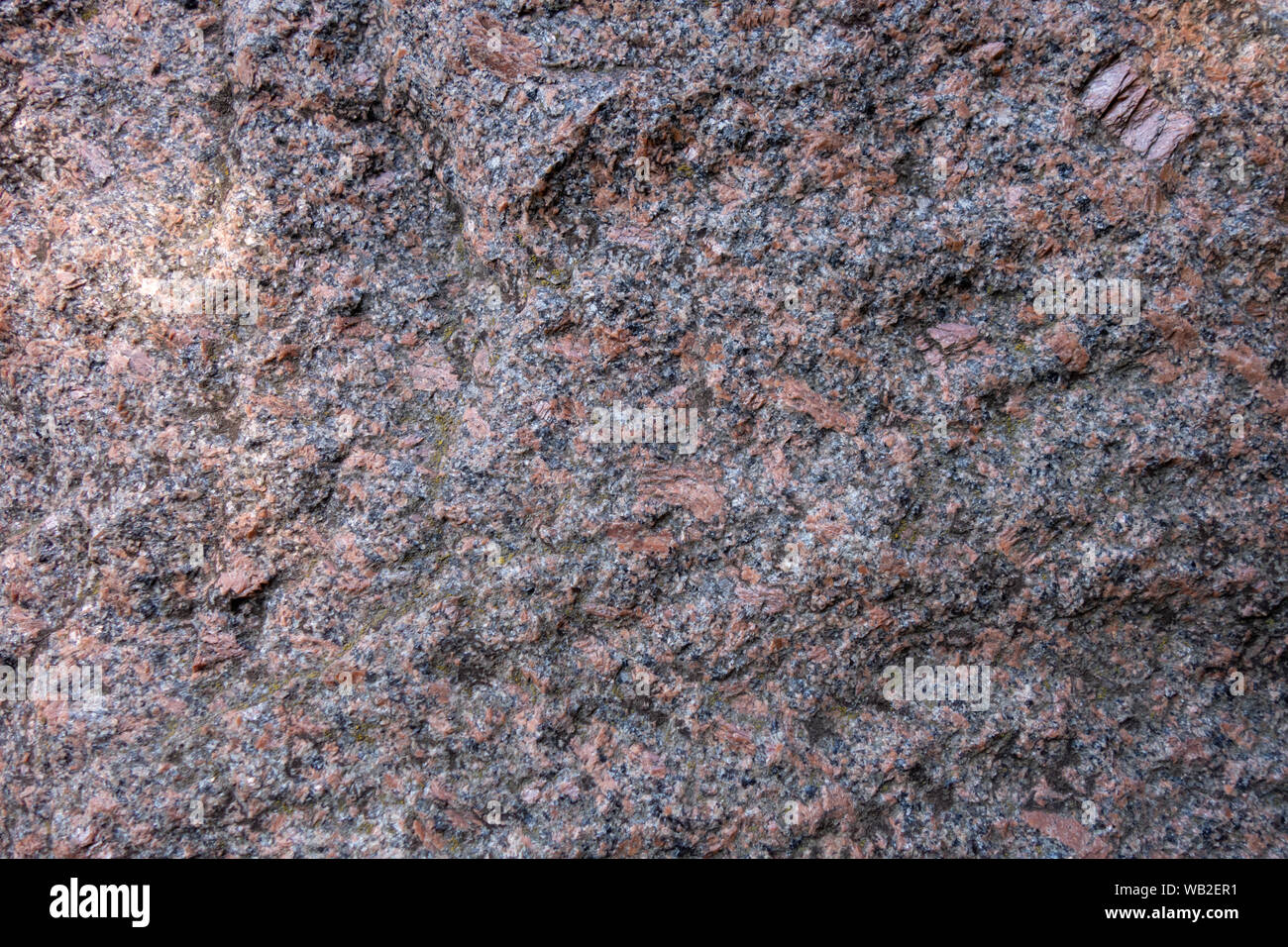 The structure of red and black granite. The texture of natural stone ...