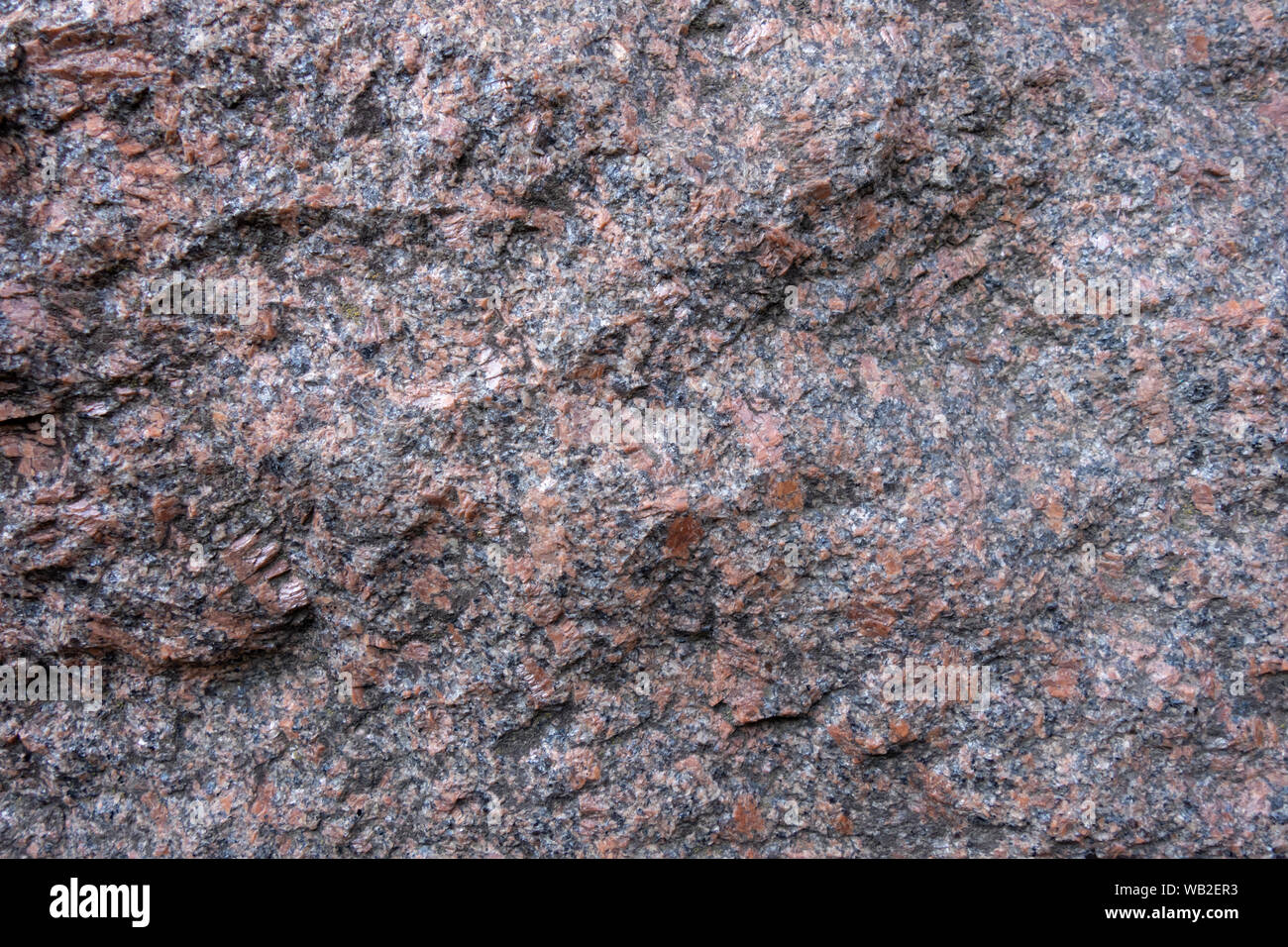 The structure of red and black granite. The texture of natural stone ...