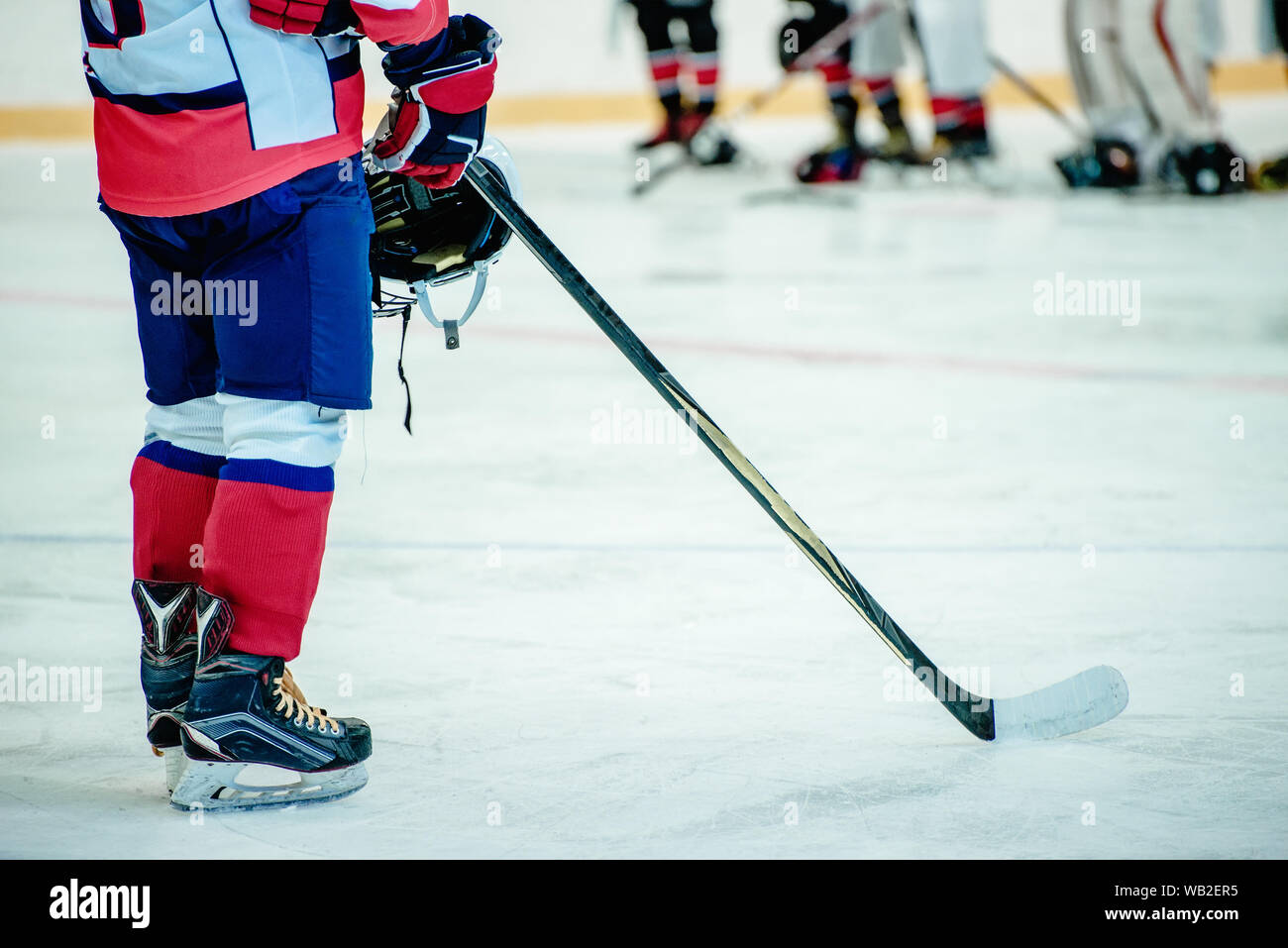hockey player and stick in the ice arena at shallow depth of field ...