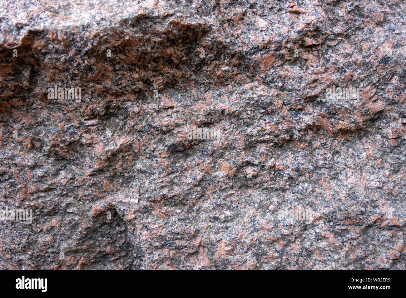 The structure of red and black granite. The texture of natural stone ...