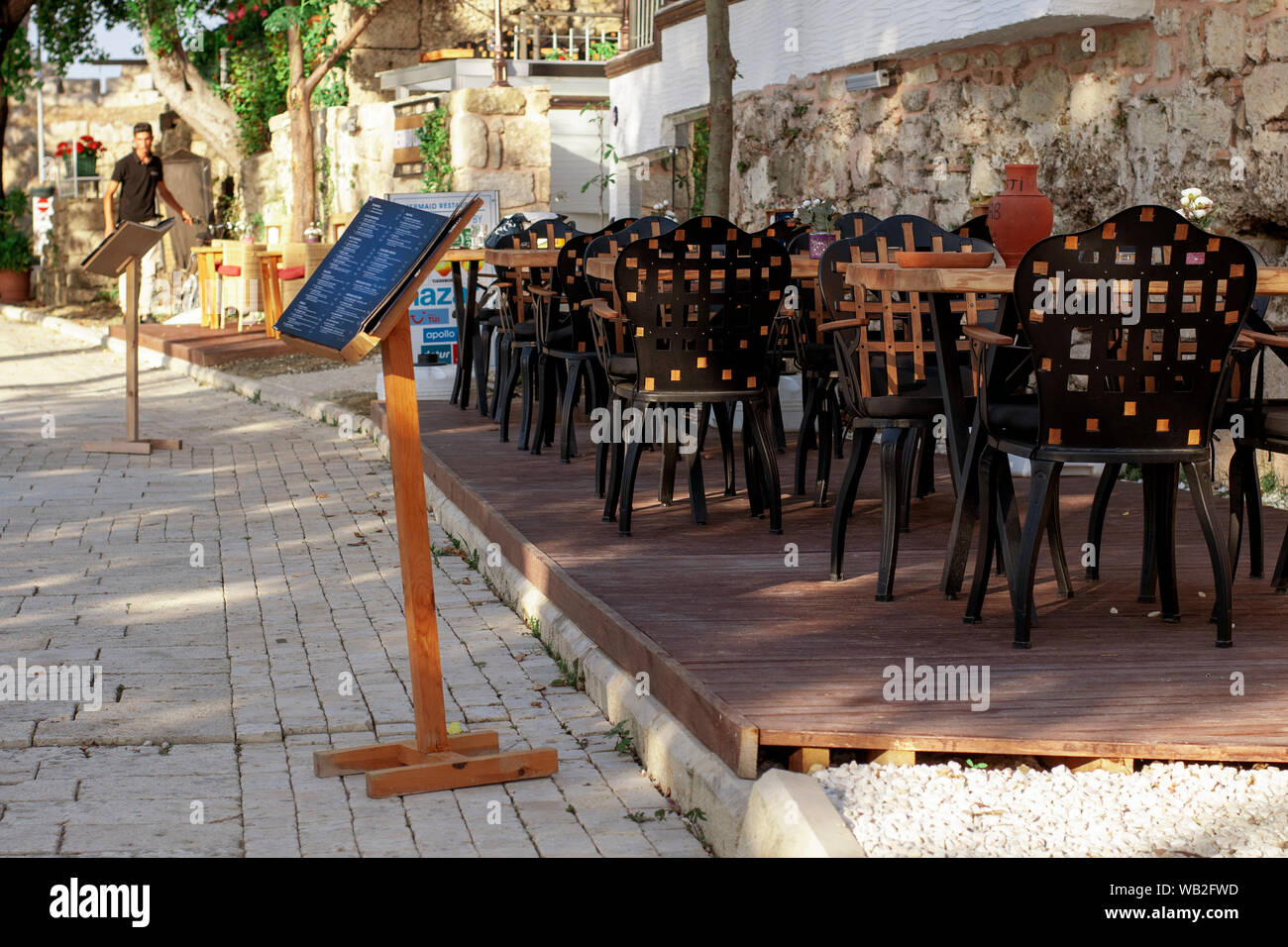 General view of the restaurant with a summer terrace in summer, a menu ...