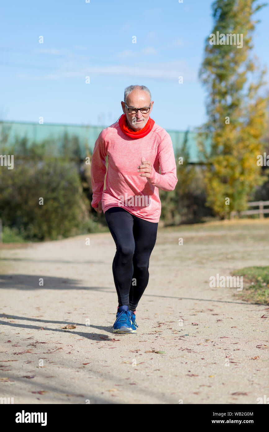 Senior runner while training for a competition Stock Photo - Alamy