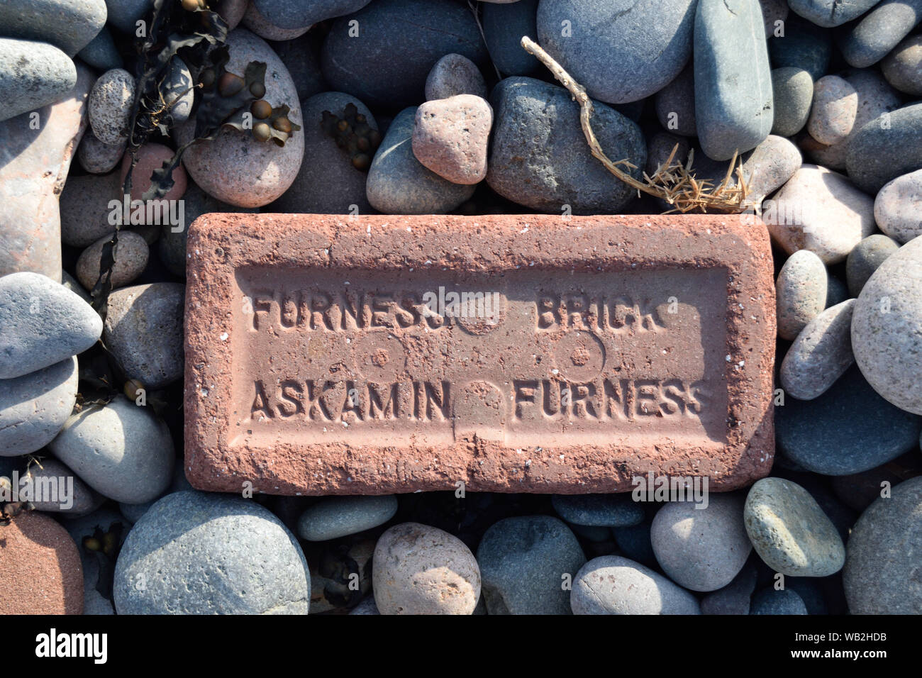 Old brick from Furness Brick Co, Askham in Furness, Cumbria, on stones ...