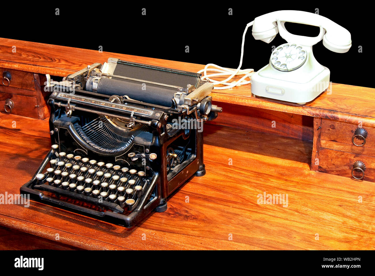 Vintage black typewriter and old white phone Stock Photo - Alamy