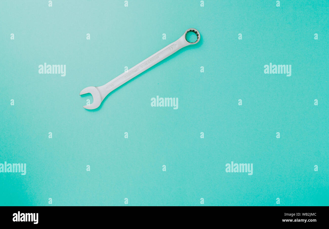 Chrome spanner placed on electric green background - Flat layout Stock ...